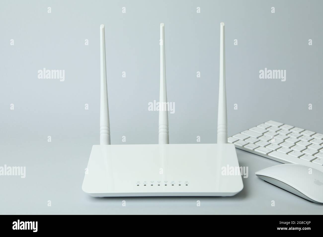Workplace with Wi - fi router on gray background Stock Photo - Alamy