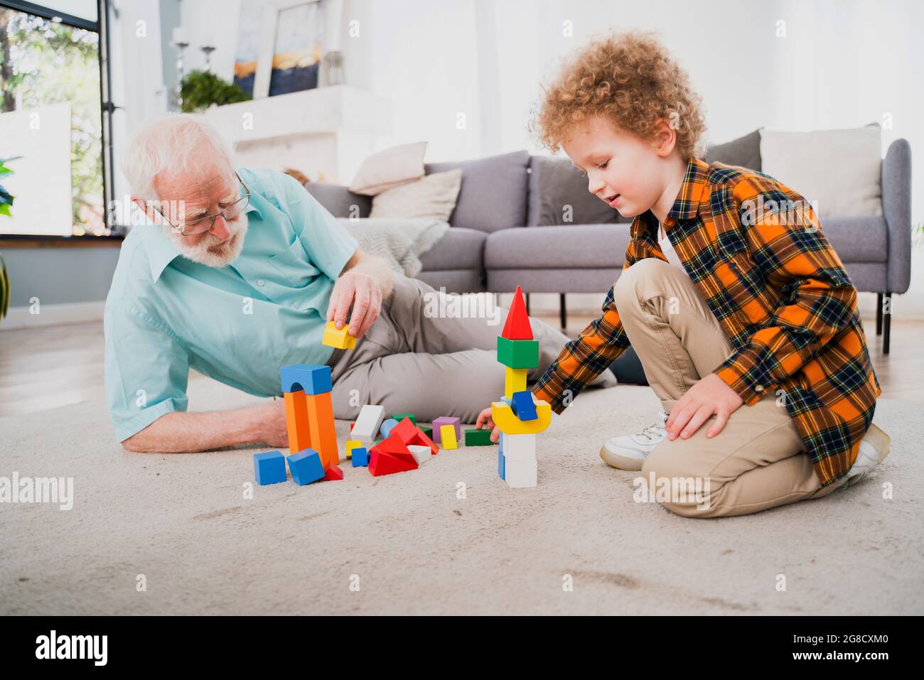 Grandparents and grandson playing at home - Family at home, grandfather ...