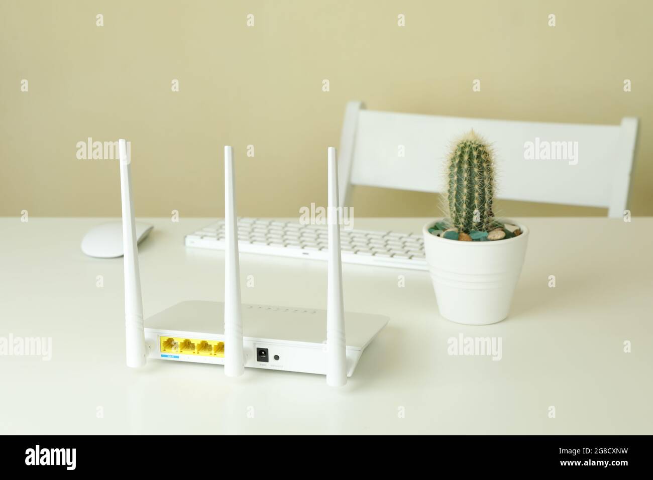 Workplace with Wi - fi router on white table Stock Photo - Alamy