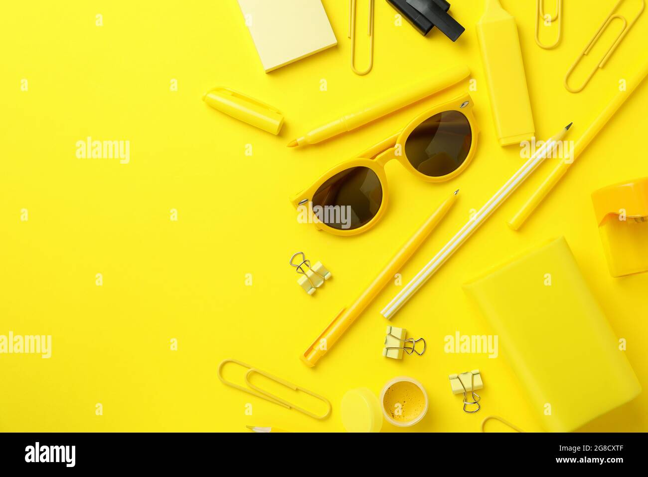 Different stationary on yellow background, space for text Stock Photo ...
