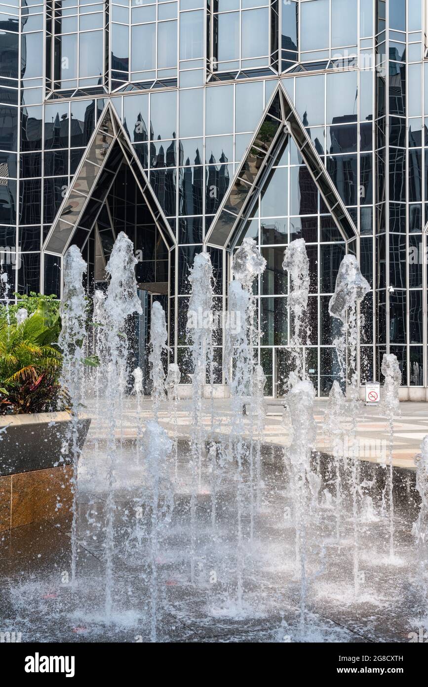 Frozen water from fountain in front of reflective office building in ...