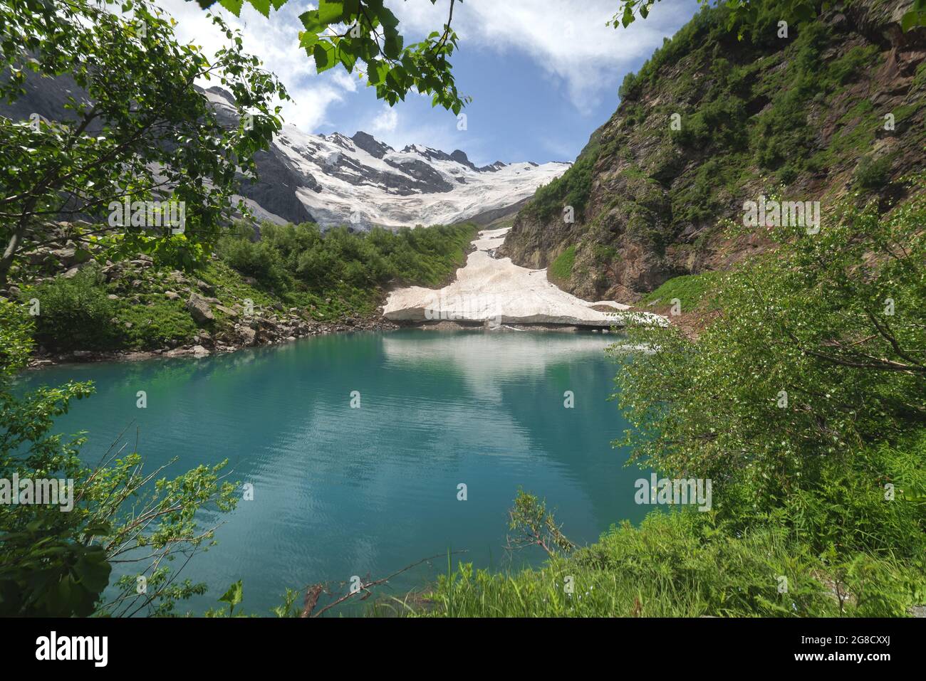mountain lake Turie with the remains of an avalanche in Dombai Stock ...