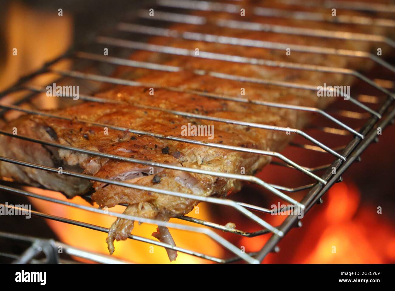 Ribs pork in brazilian barbecue. With fire background. Close up Stock ...