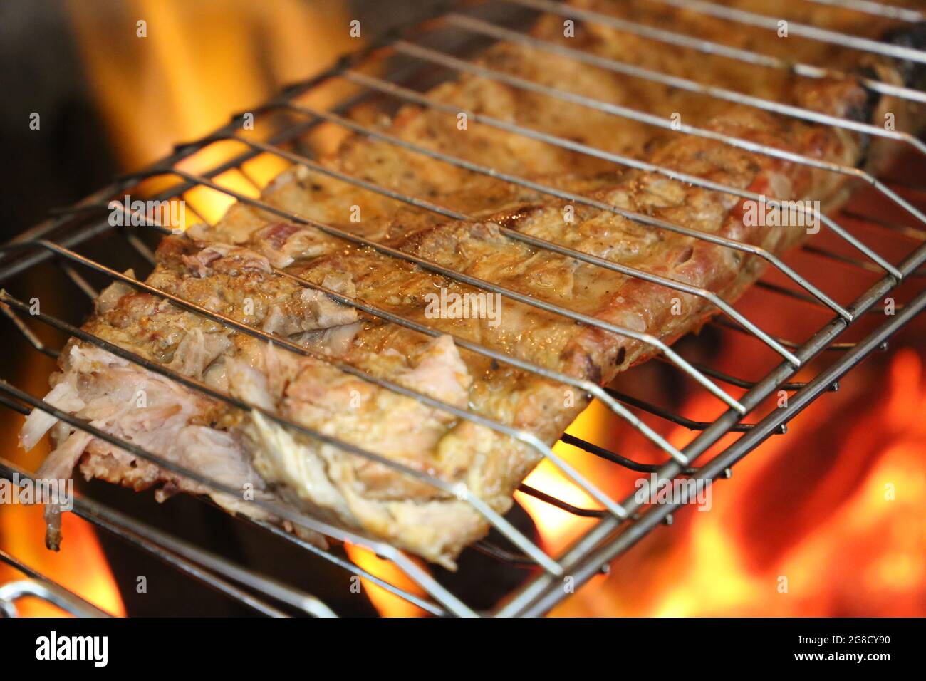 Ribs pork in brazilian barbecue. With fire background. Close up Stock ...
