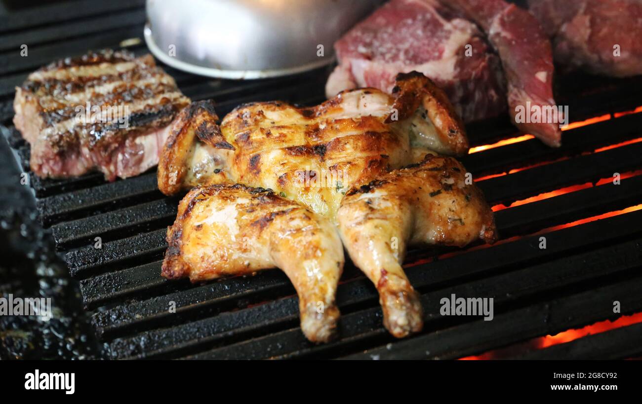 Whole chicken grilled on a barbecue. Brazilian food Stock Photo - Alamy