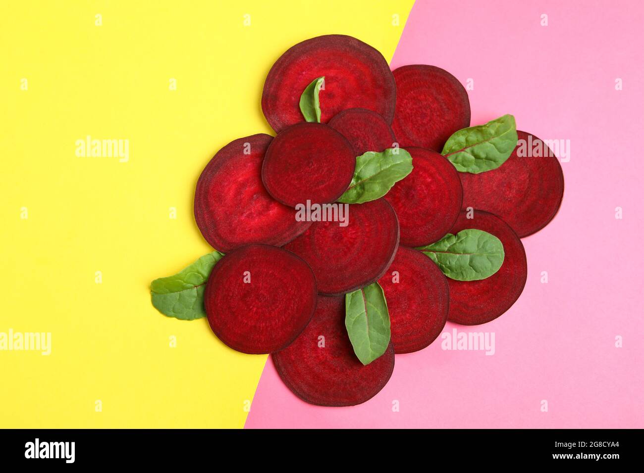 Ripe red beet with leaves on two tone background Stock Photo - Alamy