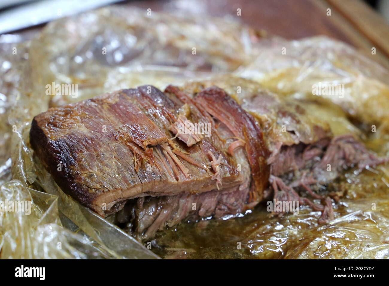 Costela. Delicious roast rib with big bones. Served on a wooden board Stock Photo - Alamy