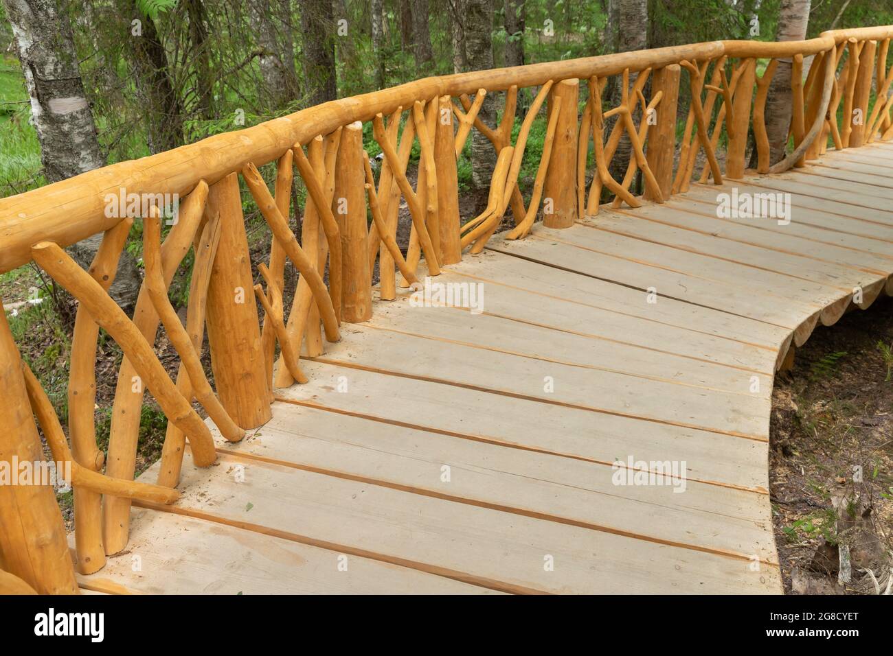 Turning wooden footbridge in summer park, background photo Stock Photo ...
