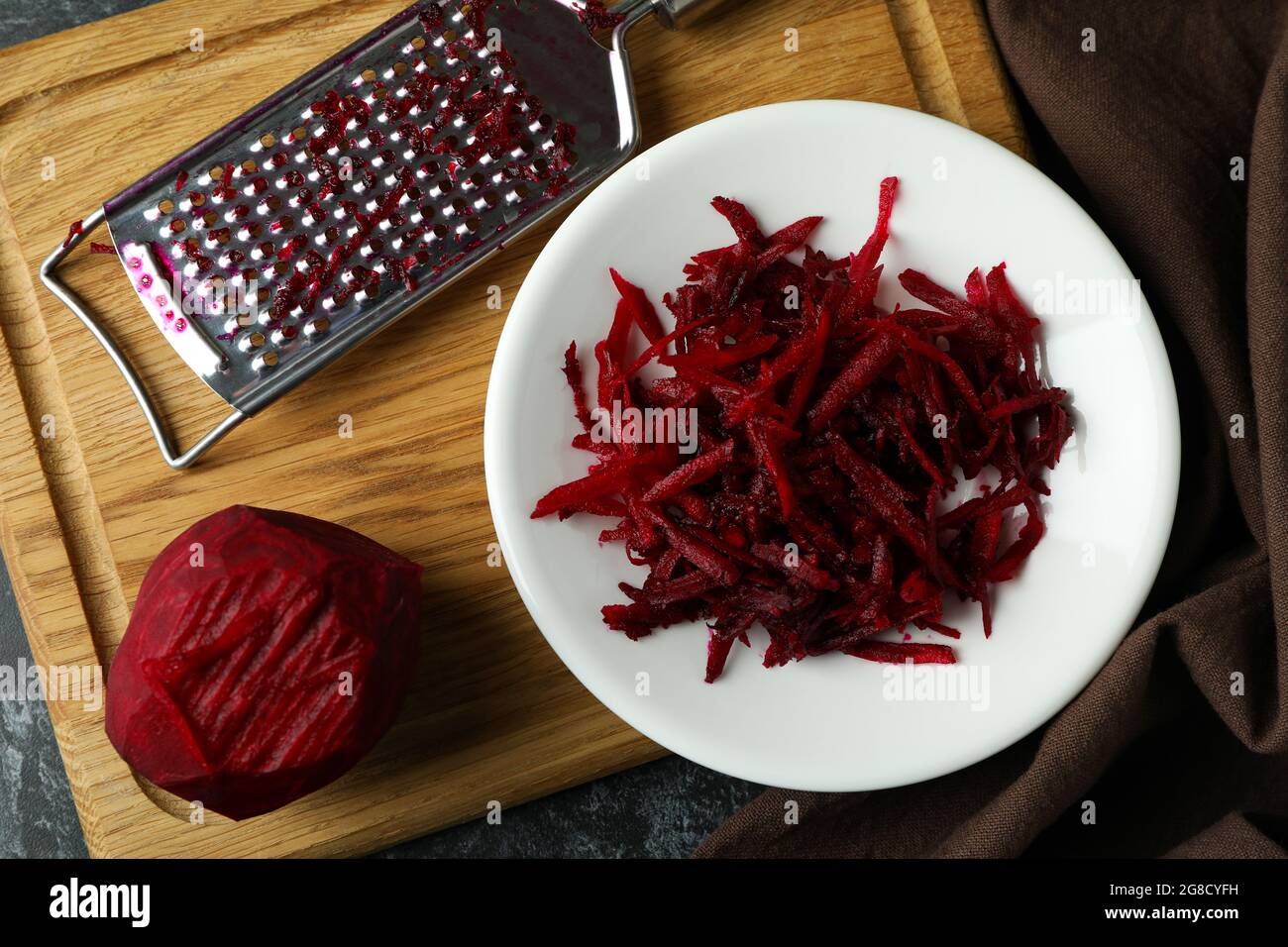 Fresh grated beets on black smokey table Stock Photo - Alamy