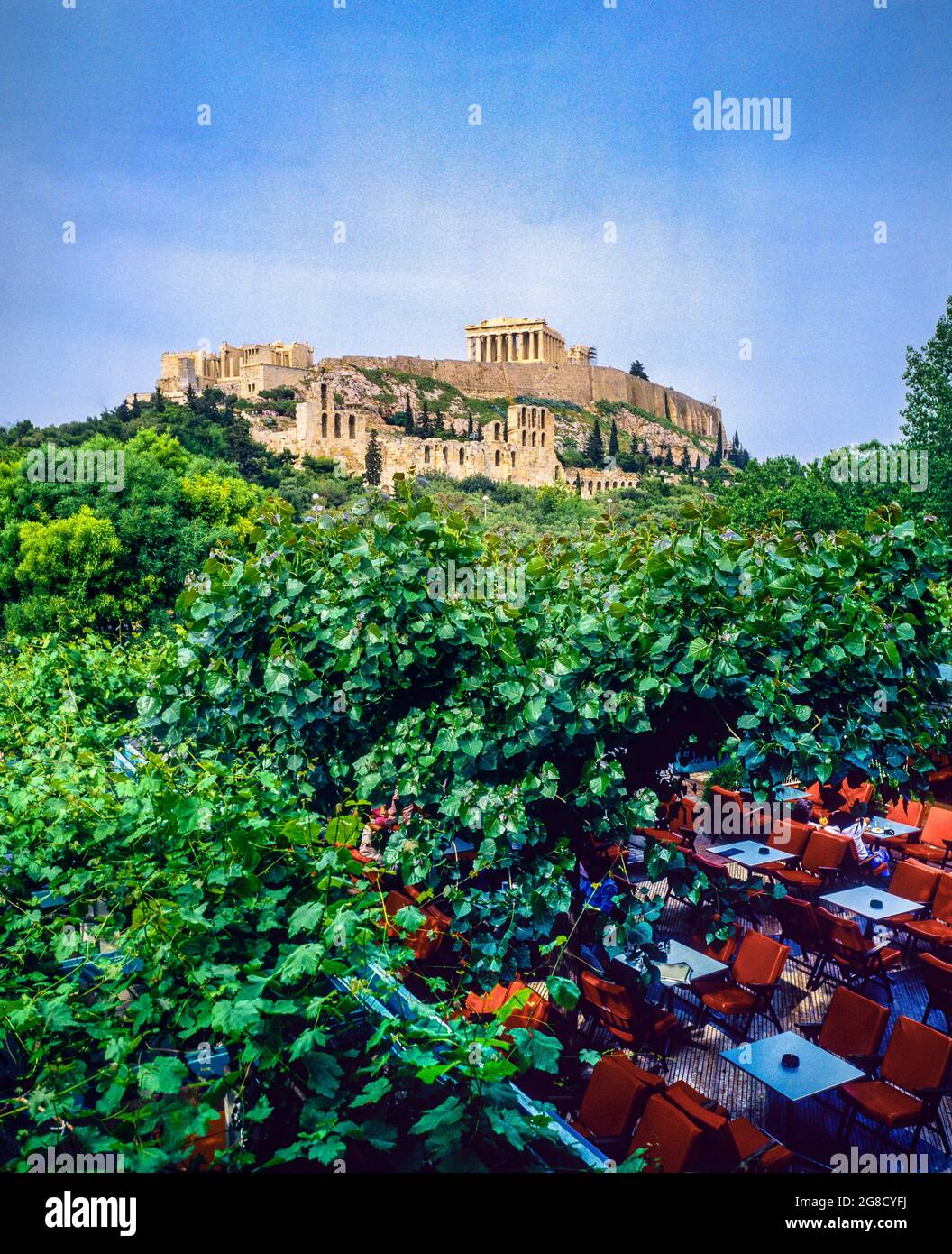 Athens, shaded restaurant terrace, Acropolis hill with Parthenon temple ...