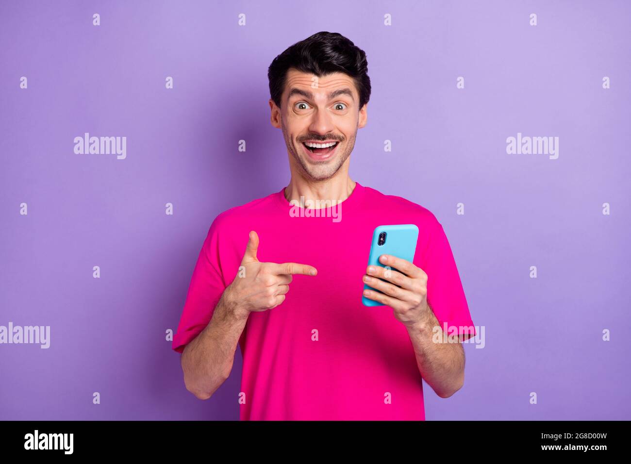 Photo of funky sweet young guy dressed pink t-shirt pointing finger ...