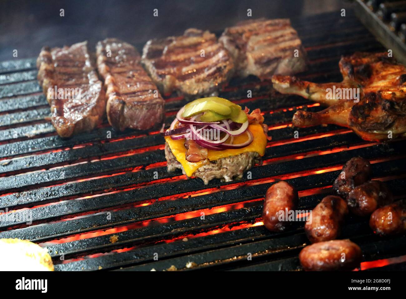 full grill on a Brazilian barbecue. Steaks, Burgers, Sausages Stock ...