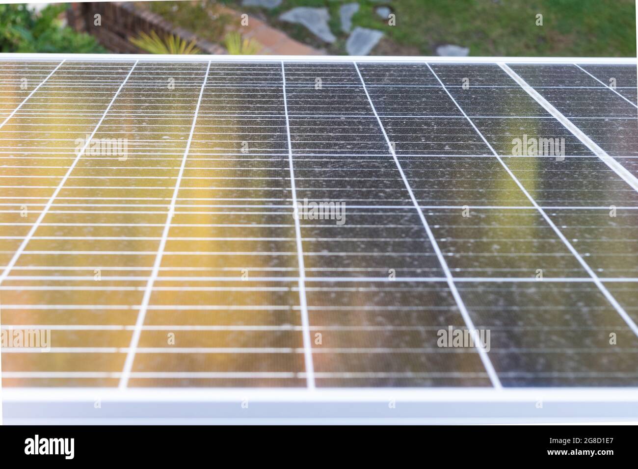 Solar panel on top of a roof with a garden underneath Stock Photo - Alamy