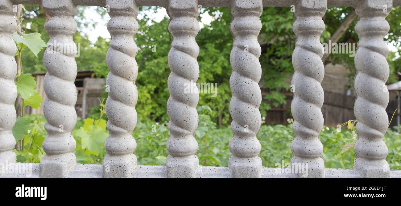Concrete Fence and green garden background behind Stock Photo - Alamy