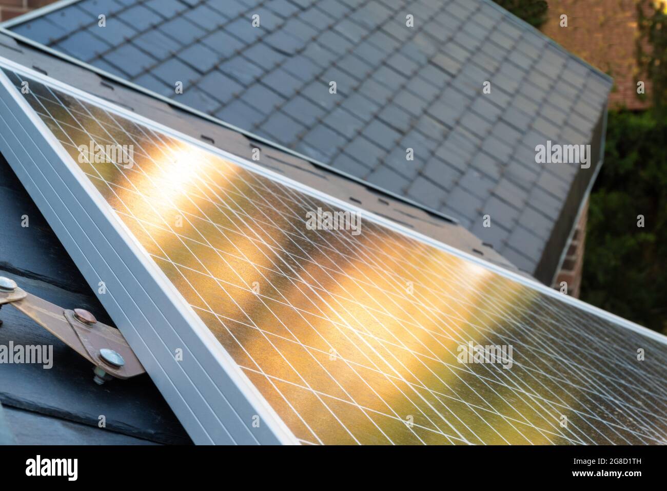 Sunset light reflection on a domestic solar panel Stock Photo - Alamy