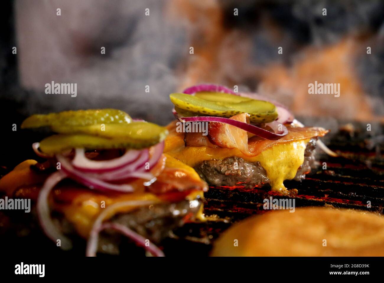 Hambúrguer. Grilled brazilian hamburger on parrilla with melted cheese ...