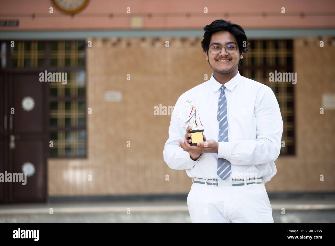portrait of a Happy Student with Prize in hand, Celebrating success ...