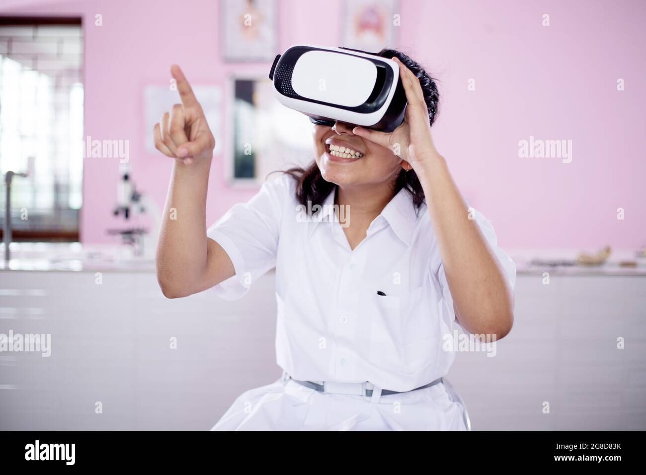 Girl wearing VR virtual reality goggles interaction headset ...