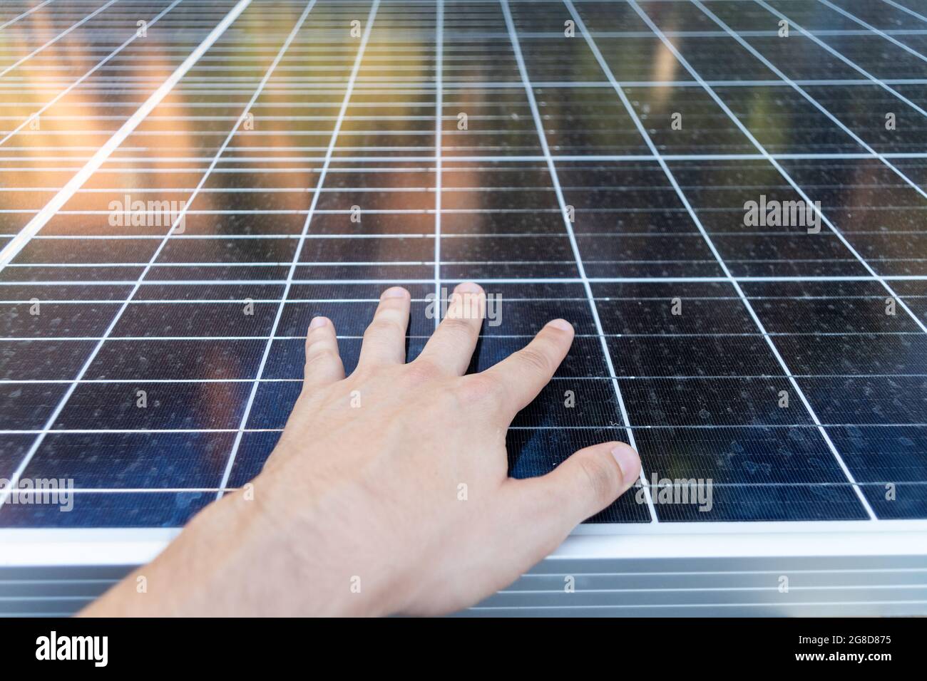 Peron touching a solar panel with colorful light reflections Stock ...