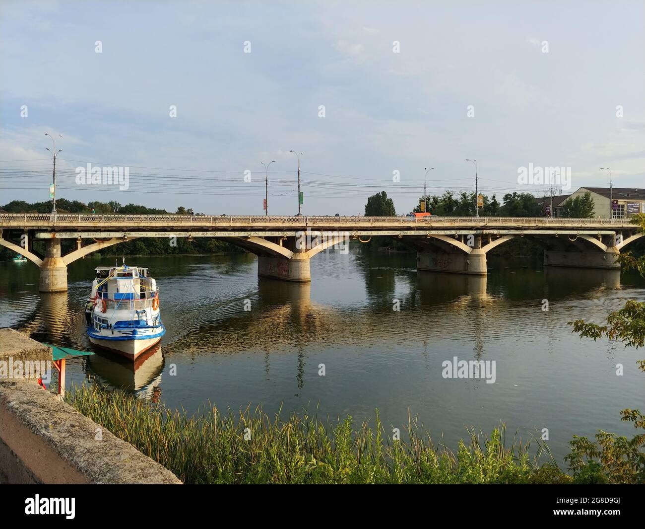 beautiful summer landscape with passenger boat docking on the river ...