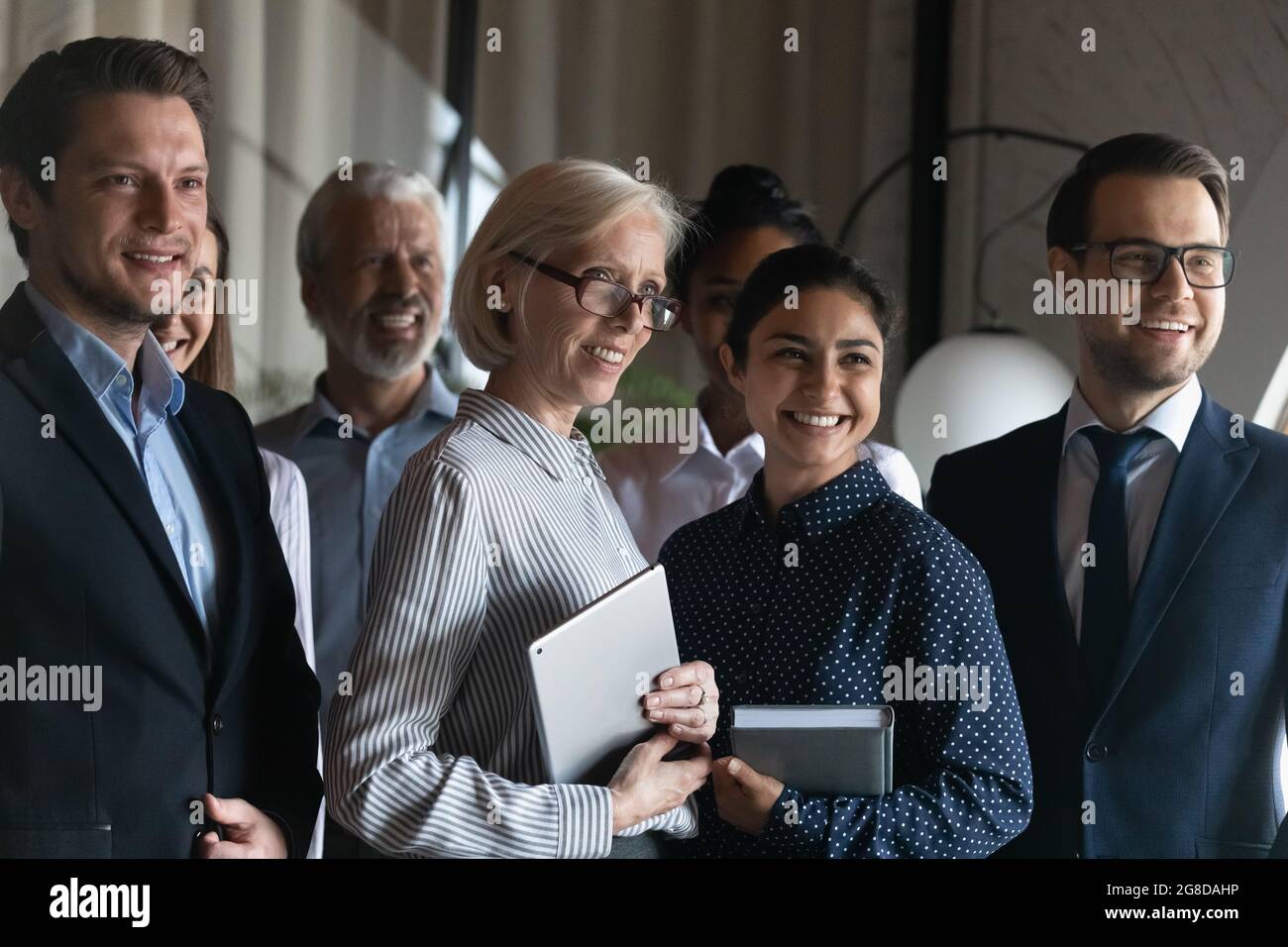 Group portrait of happy diverse employees, workers of different ages ...
