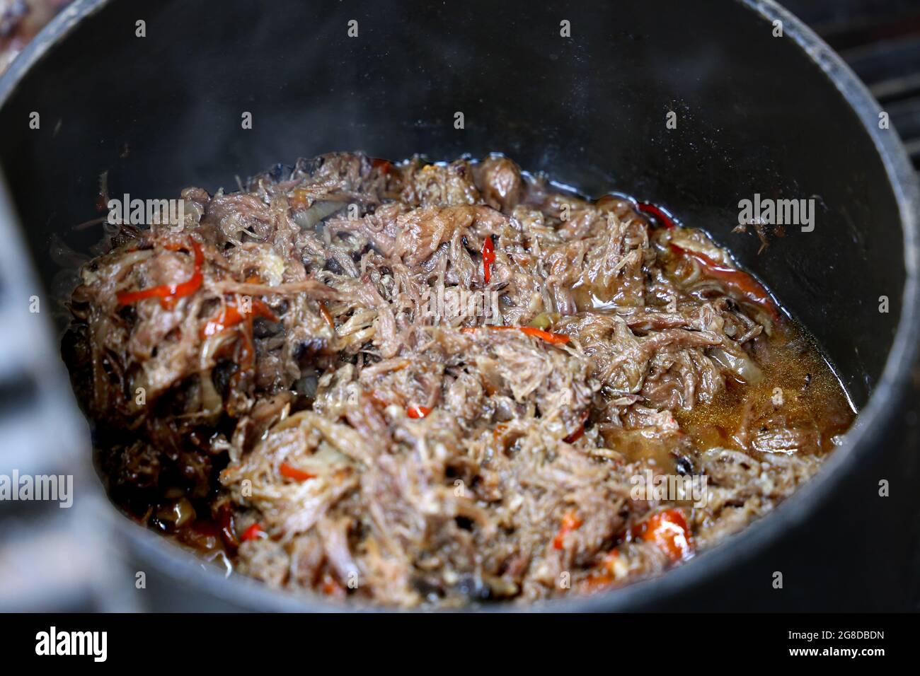 shredded ribs in a black iron pan. Brazilian food Stock Photo - Alamy