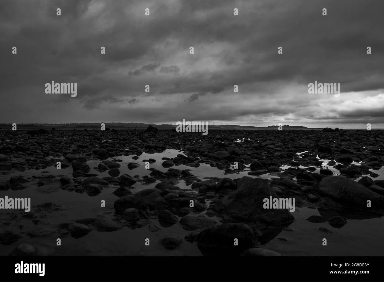 Dark clouds on the coast Black and White Stock Photos & Images - Alamy