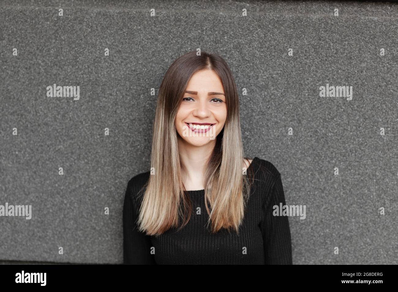 Successful woman portrait. Young businesswoman standing in front of a ...