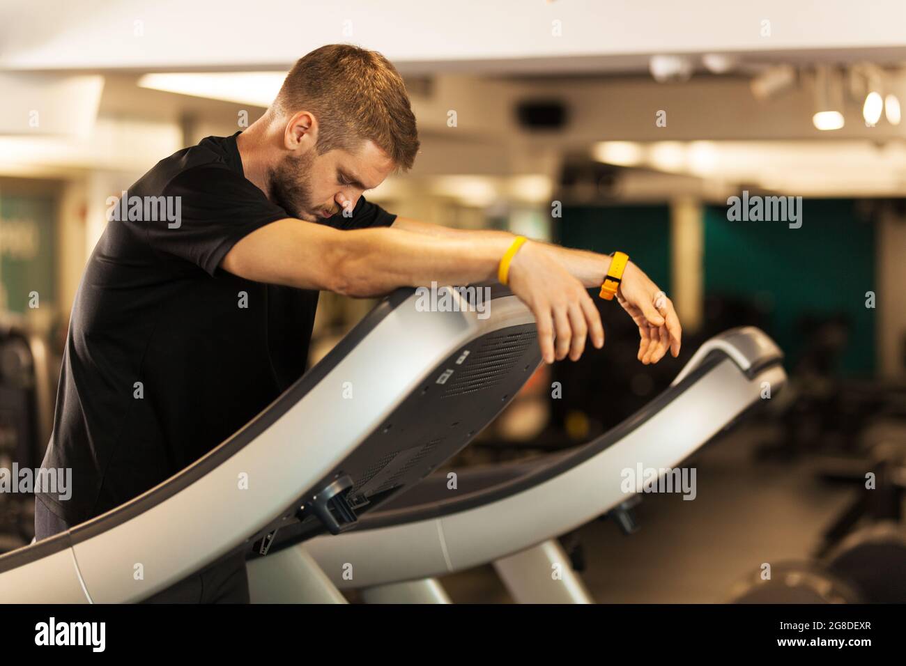 Tired guy walking on a treadmill. Exhausted man reating Stock Photo - Alamy