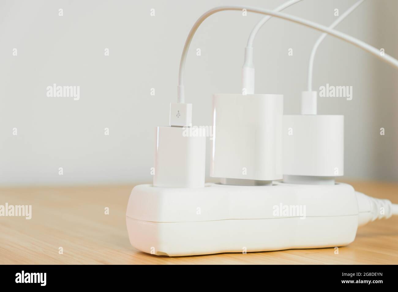 The electrical extension strip with connected white power plugs on the ...