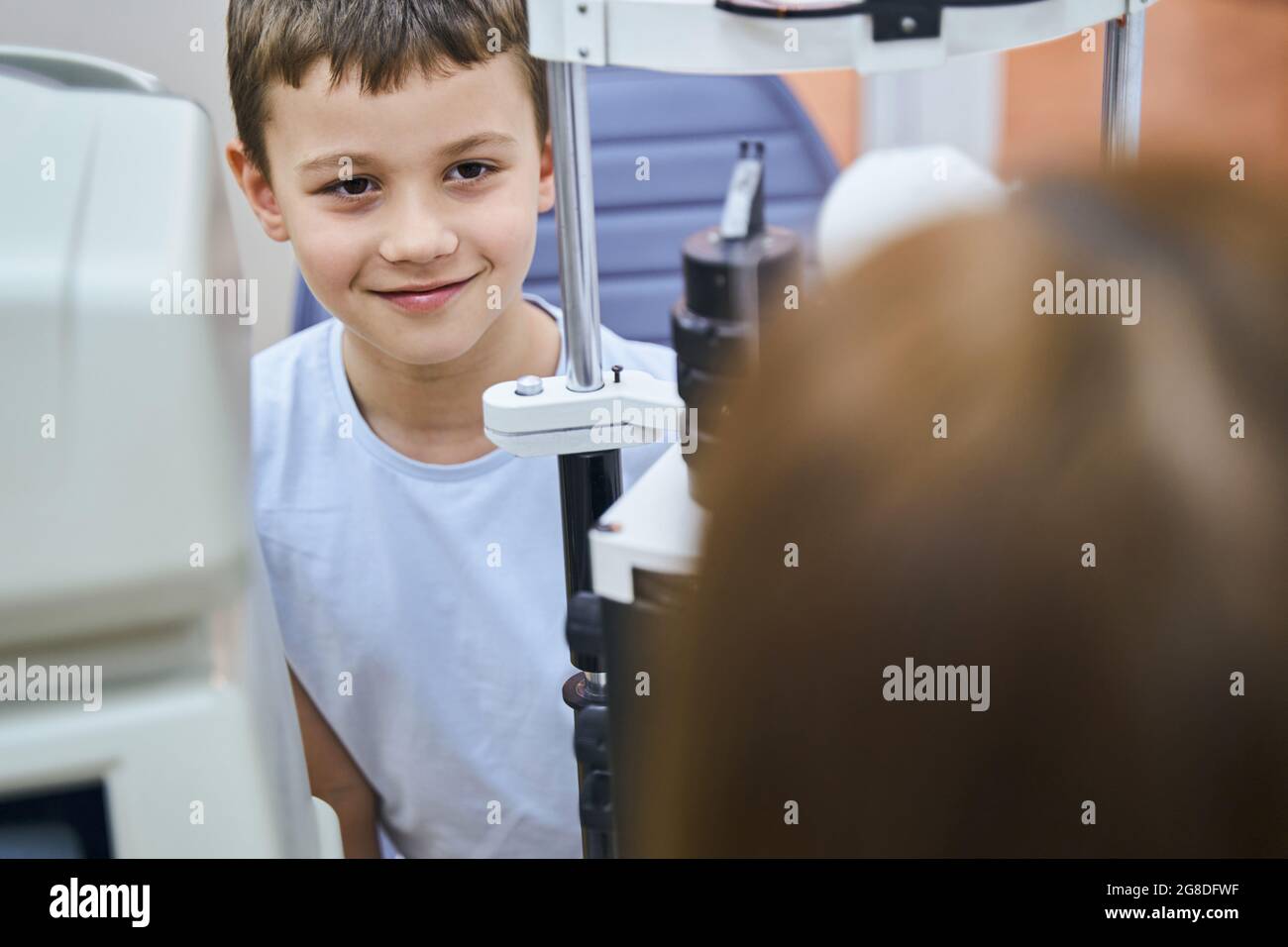 Cute boy having eye examination in modern clinic Stock Photo - Alamy