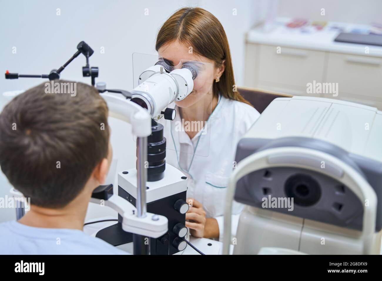 Doctor examining child eyes with ophthalmic equipment Stock Photo - Alamy