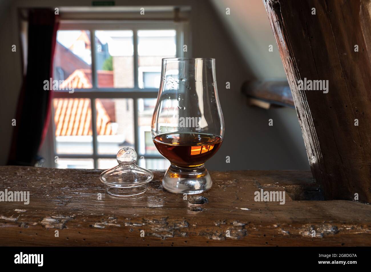 Dram of single malt scotch whisky served in tasting glass with view on ...