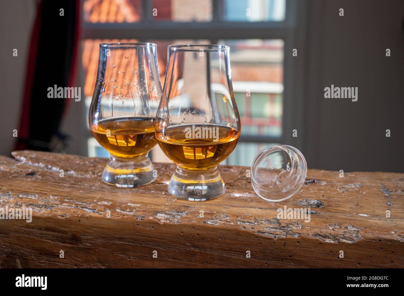 Dram of single malt scotch whisky served in tasting glass with view on ...