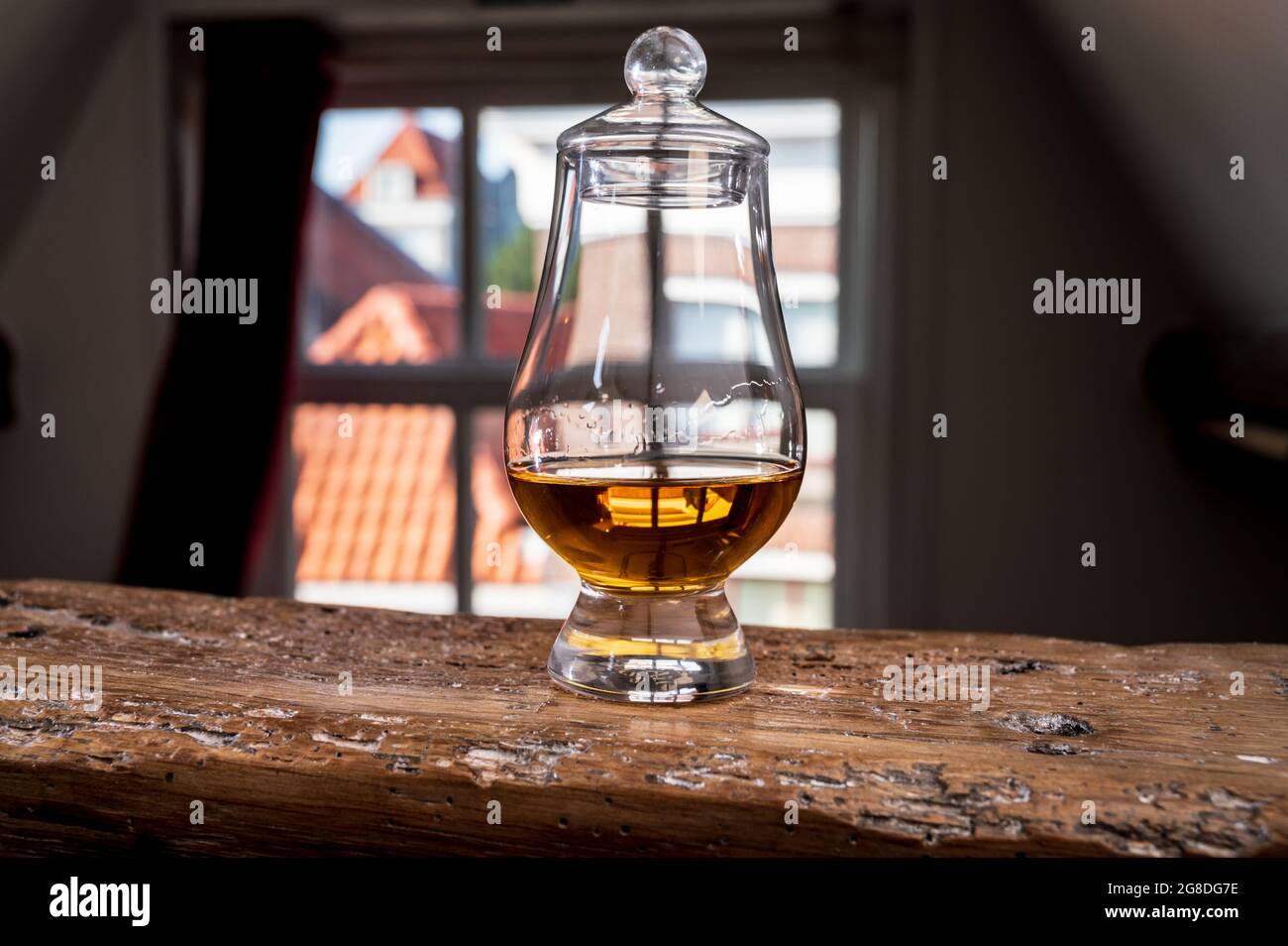 Dram of single malt scotch whisky served in tasting glass with view on ...