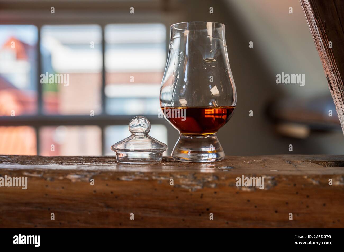 Dram of single malt scotch whisky served in tasting glass with view on ...