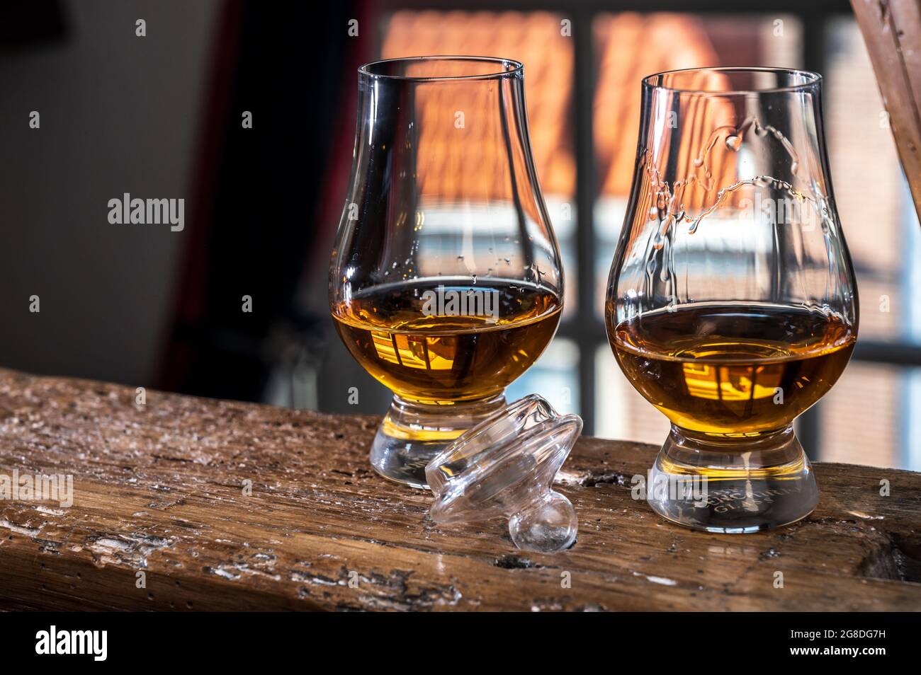 Dram of single malt scotch whisky served in tasting glass with view on ...
