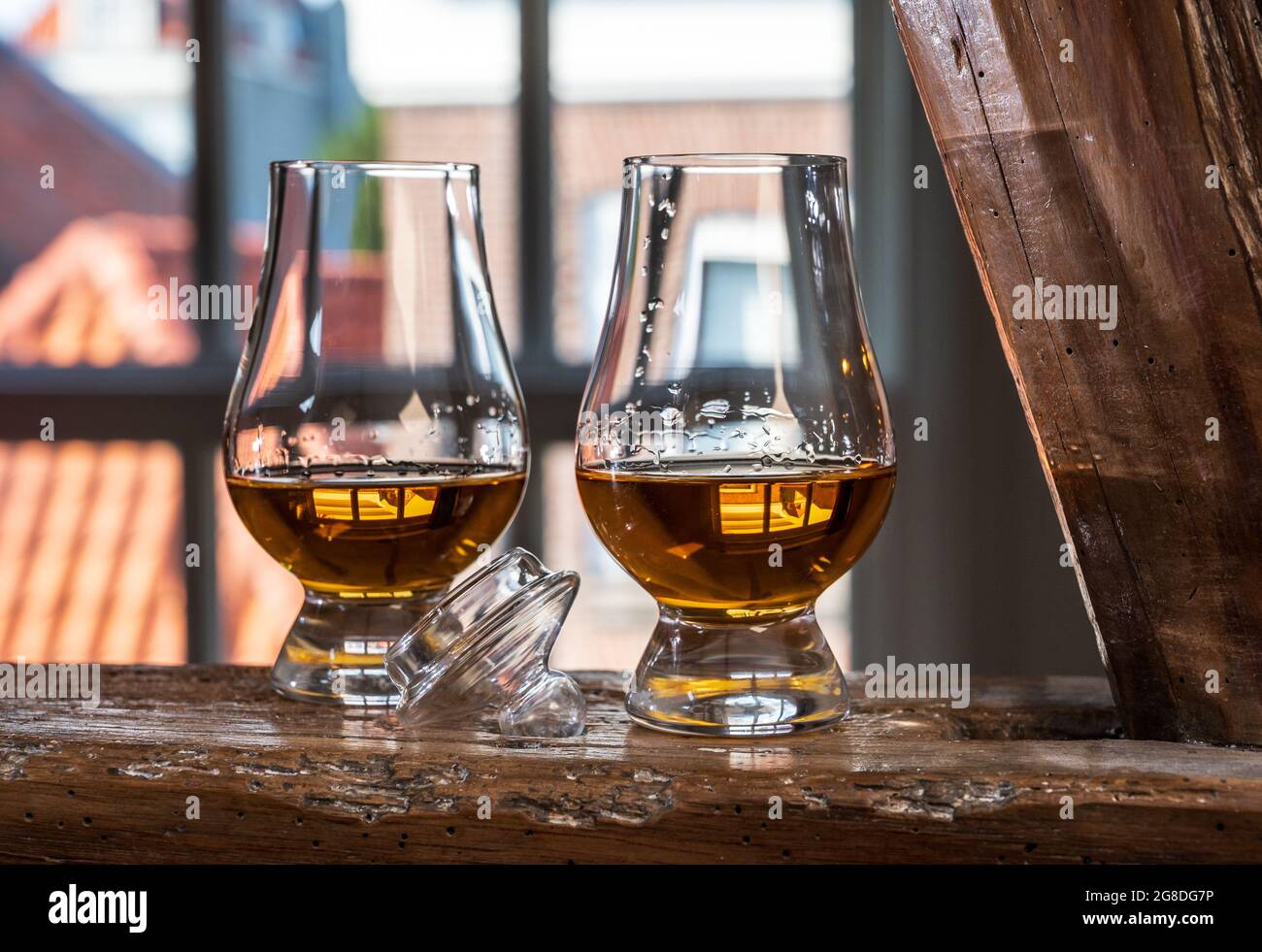 Dram of single malt scotch whisky served in tasting glass with view on ...