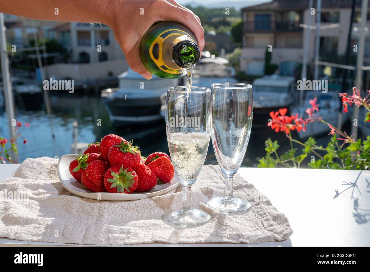 Summer party, pouring of French brut champagne sparkling wine in ...