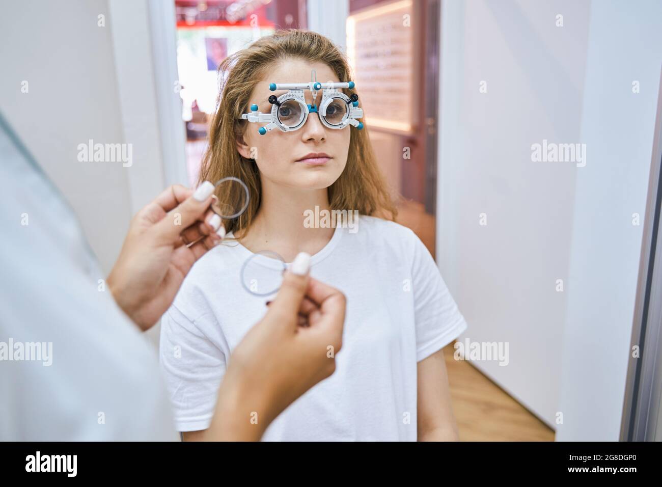 Charming woman wearing optical trial lens frame during eye exam Stock ...