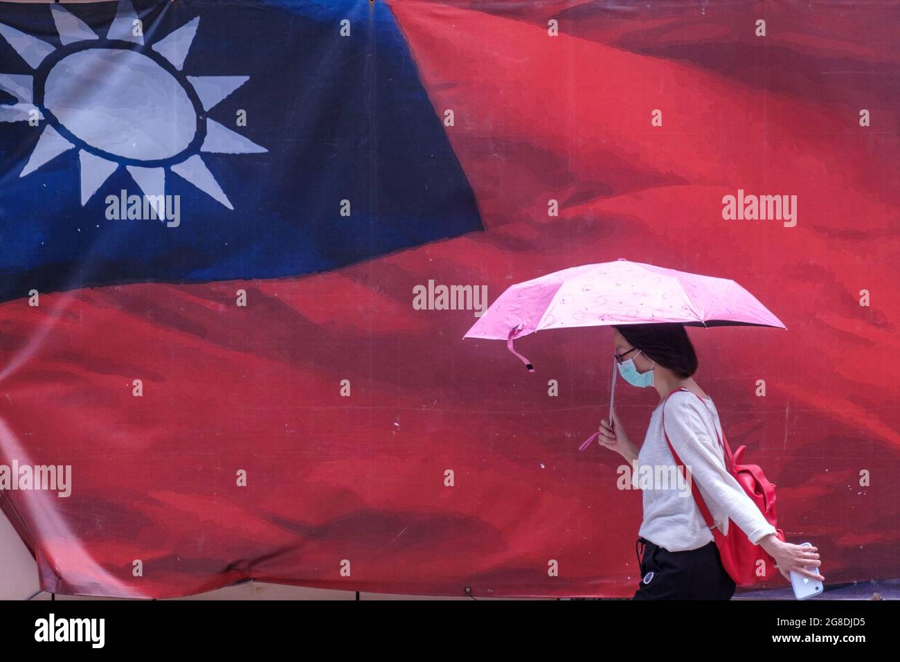 Taipei, Taiwan. 19th July, 2021. A woman wearing a face mask and ...