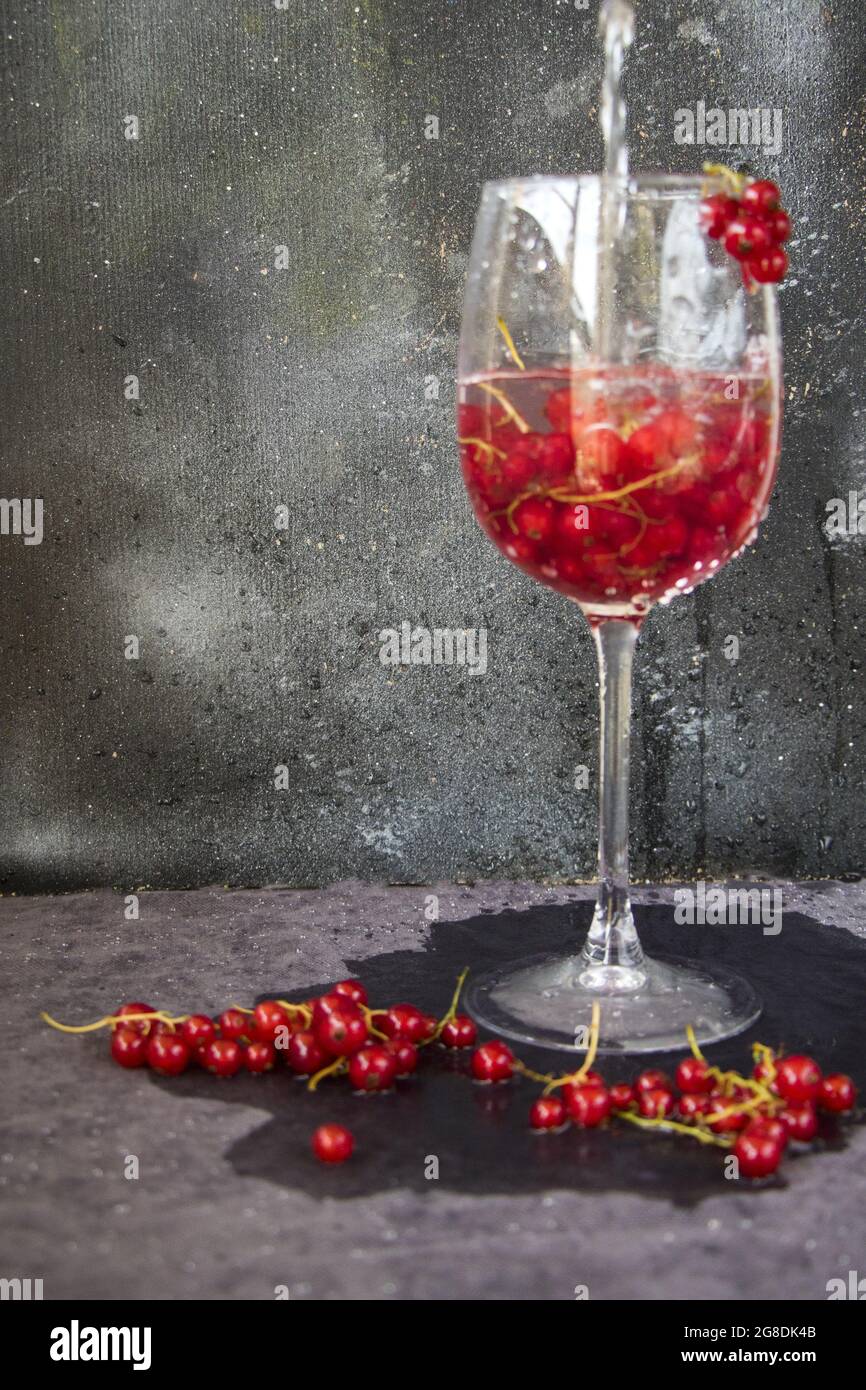 Red currants in a wine glass on a gray background Stock Photo - Alamy
