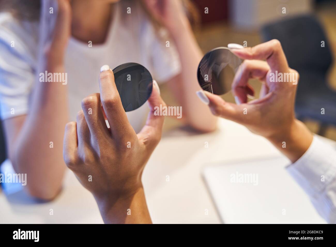 Female optician hands holding round lenses for eyeglasses Stock Photo ...