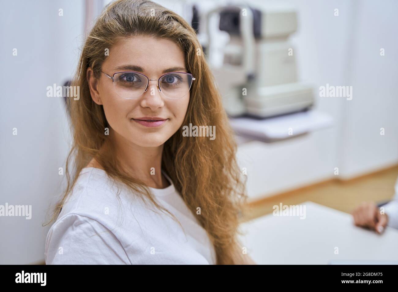 Beautiful young woman in glasses visiting optical clinic Stock Photo ...