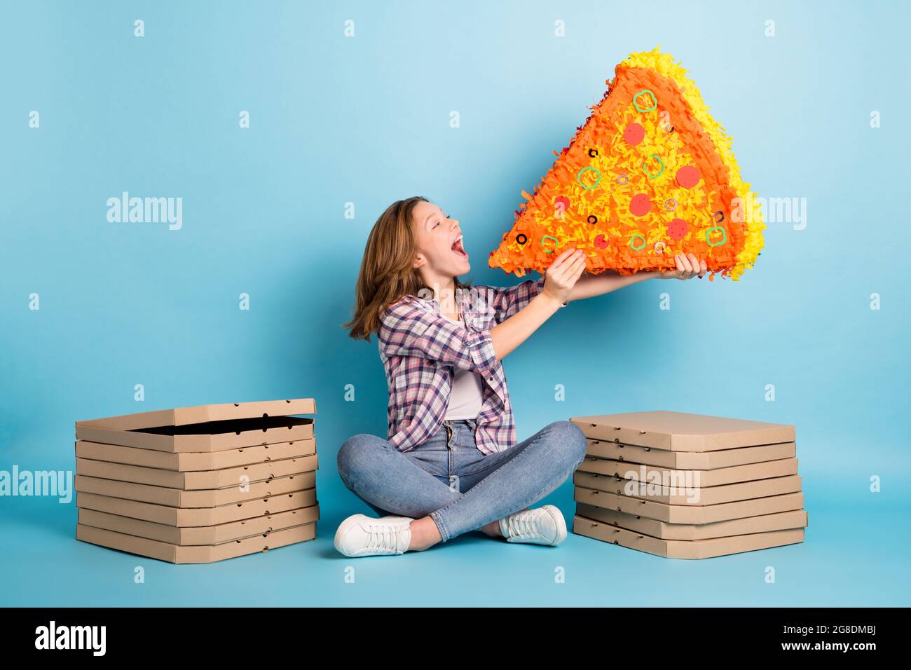 Full body photo of crazy positive pupil sit on floor hold large pizza ...