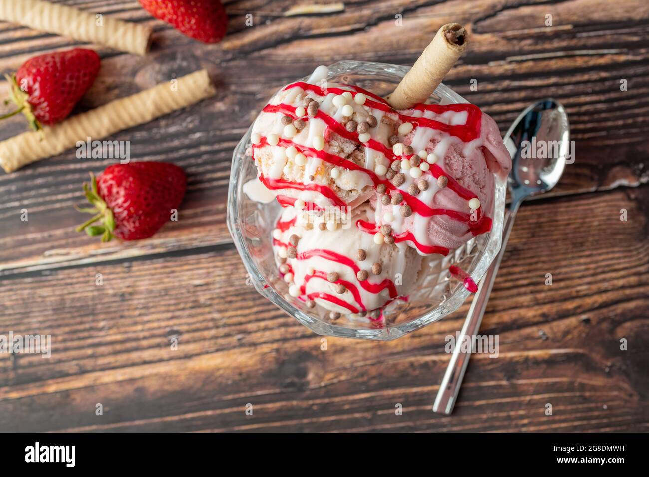 strawberry, banana and cream Roma ice cream in a glass bowl with red ...