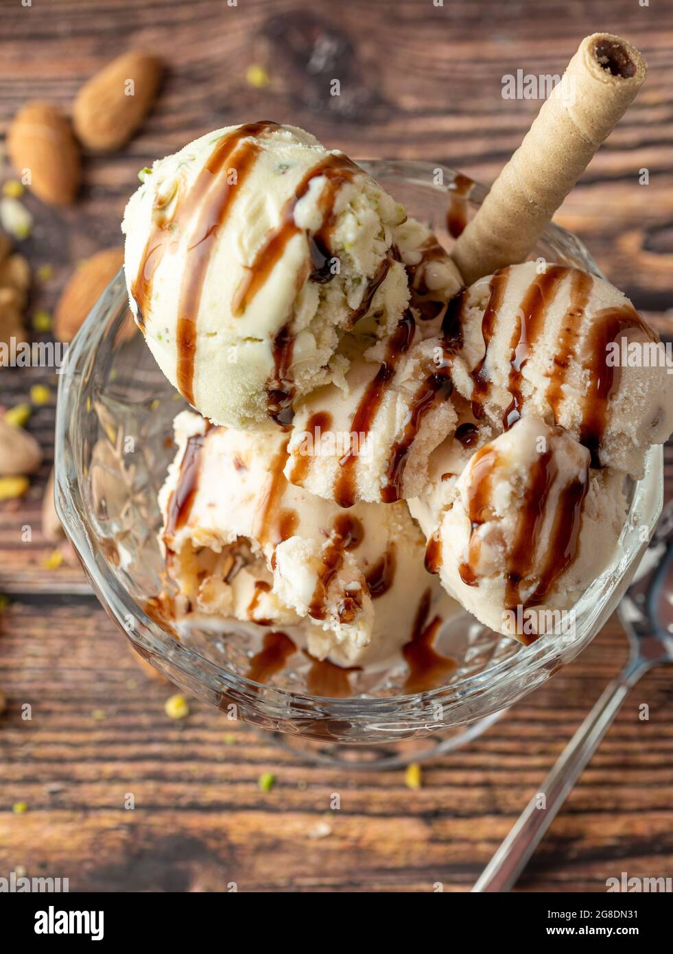 Almond, pistachio and walnut Roma ice cream in a glass bowl with ...