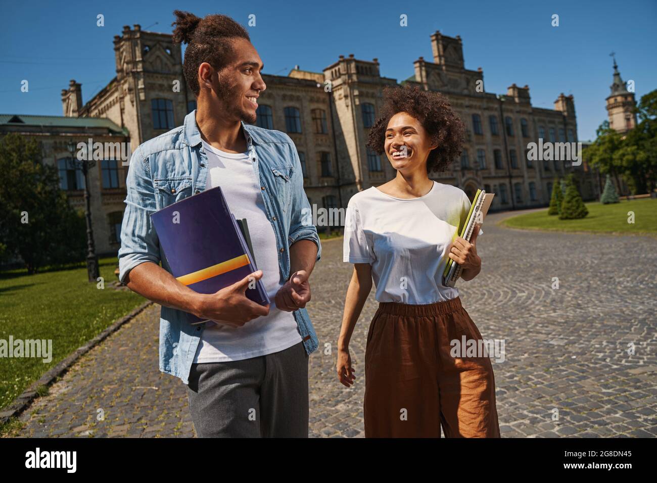 Two young people coming back from the university Stock Photo - Alamy