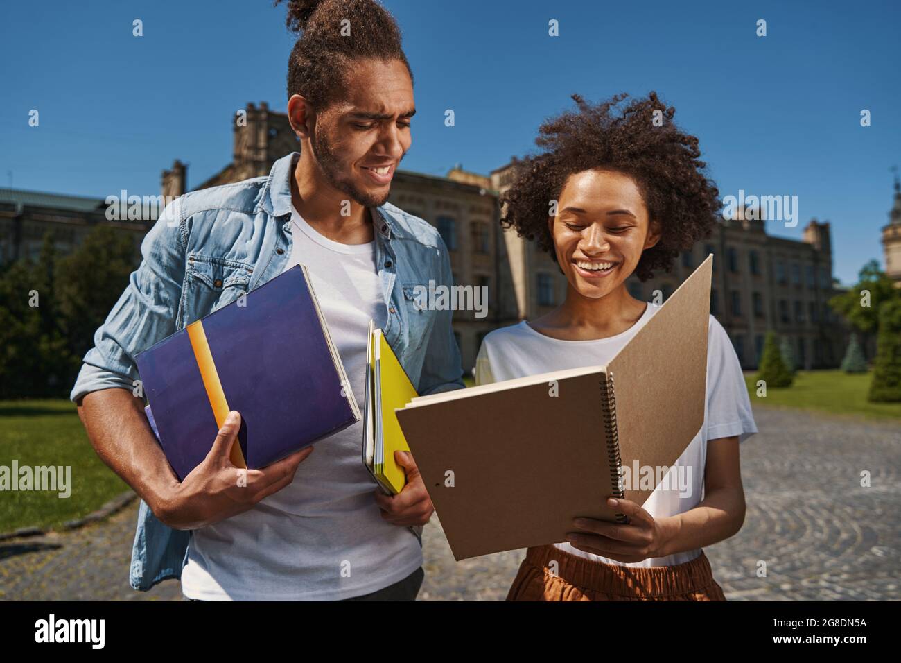 Happy friendly students looking at their notes Stock Photo - Alamy