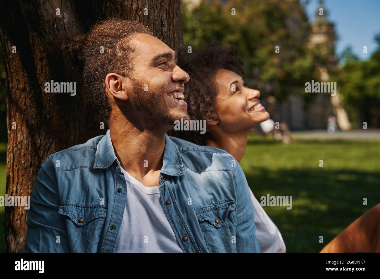 Dreamy couple expecting something pleasant and smiling Stock Photo - Alamy